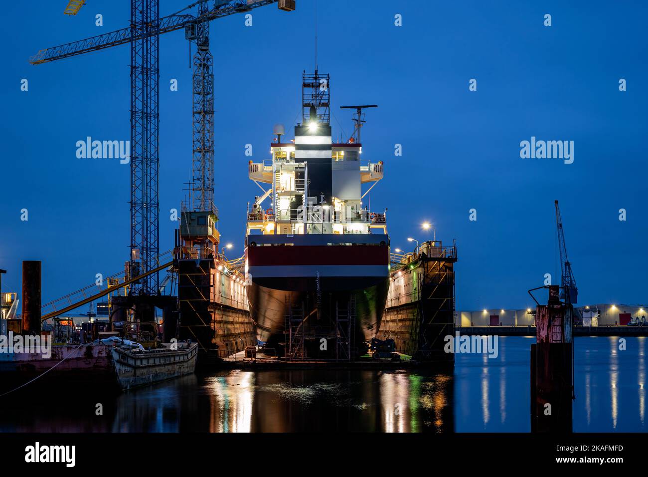 general cargo vessel in floating dock for maintenance at night Stock ...