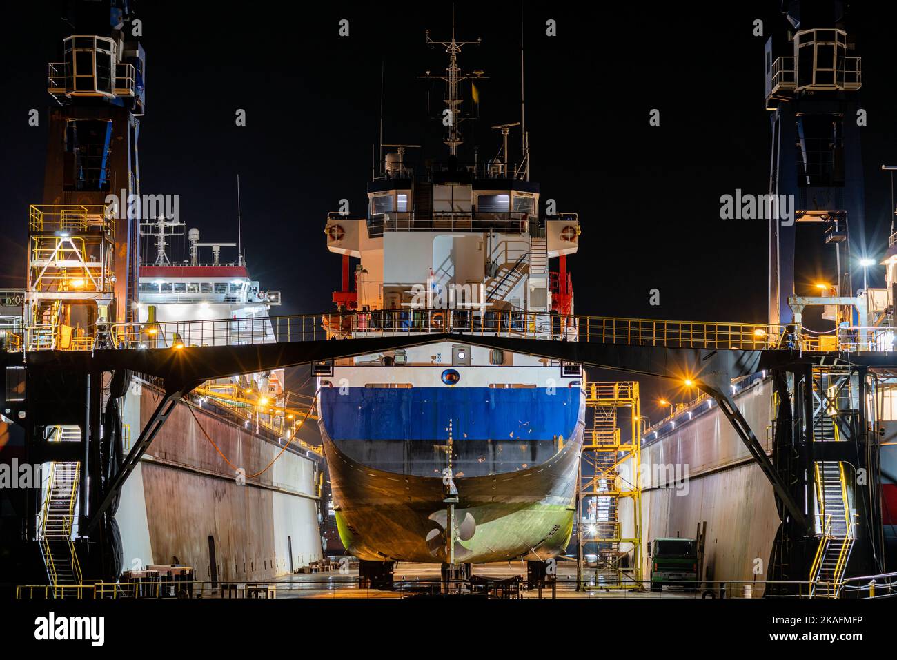 general cargo vessel in floating dock for maintenance at night Stock ...