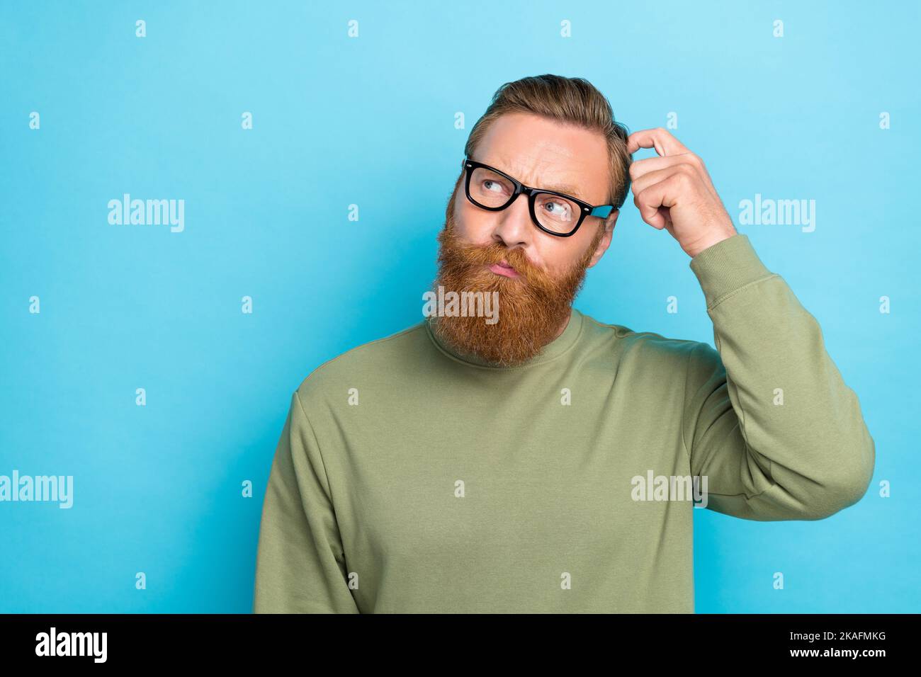 Photo portrait of attractive young man scratch head look empty space ...
