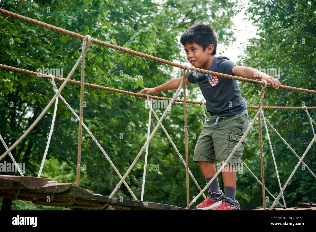 A little boy crossing a wooden bridge Stock Photo - Alamy