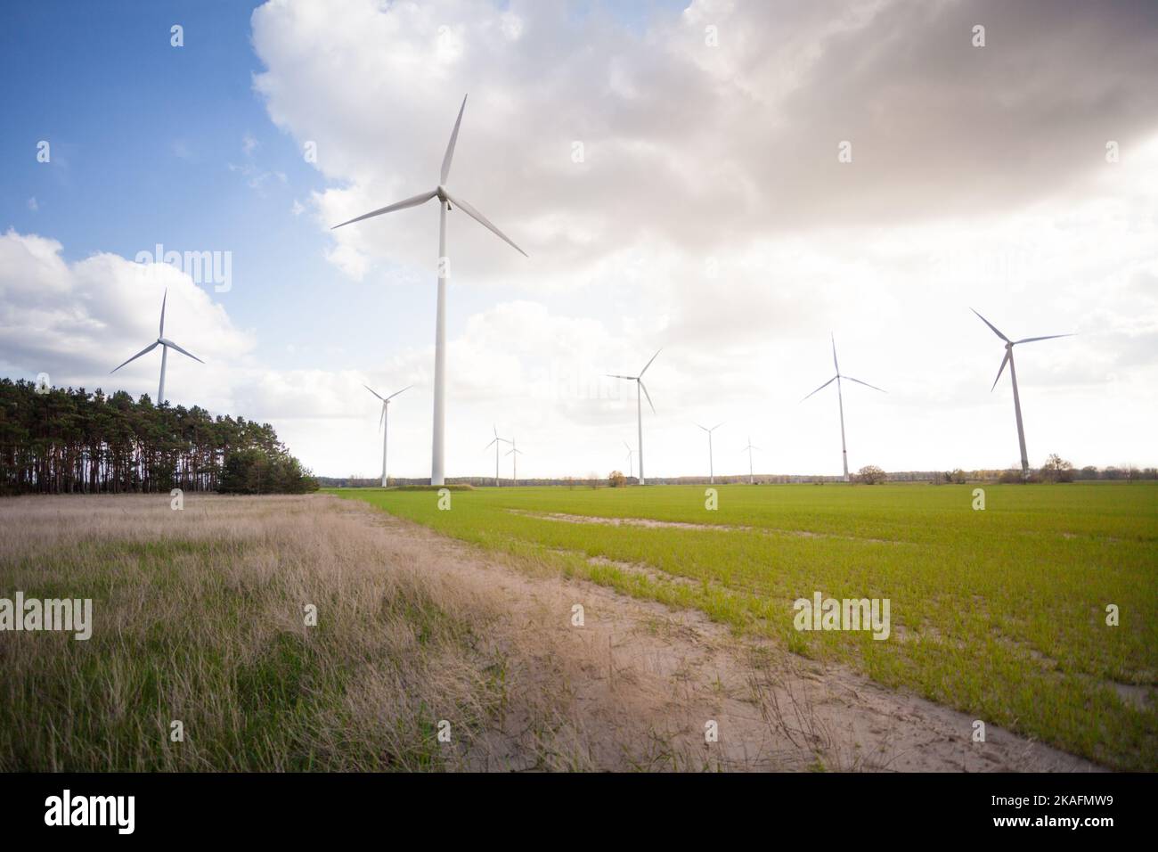 a windmill for green electricity energy on a field in good weather with ...