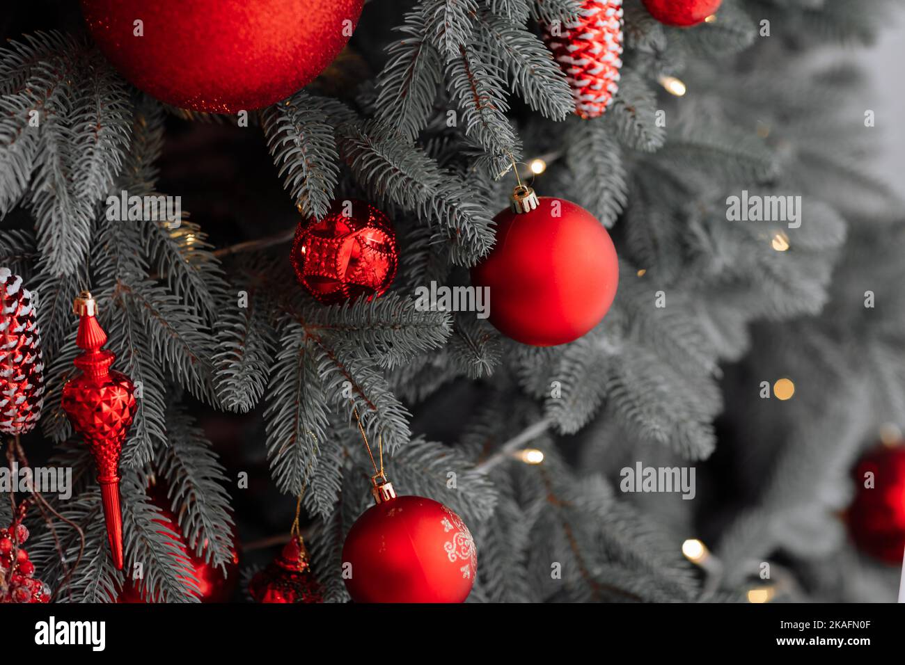 stylish christmas decorations on the tree, beautiful toys, balls, cones ...