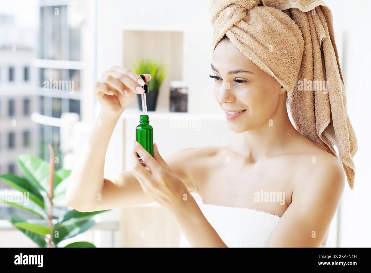 Beautiful model applying cosmetic cream treatment on her face Stock ...