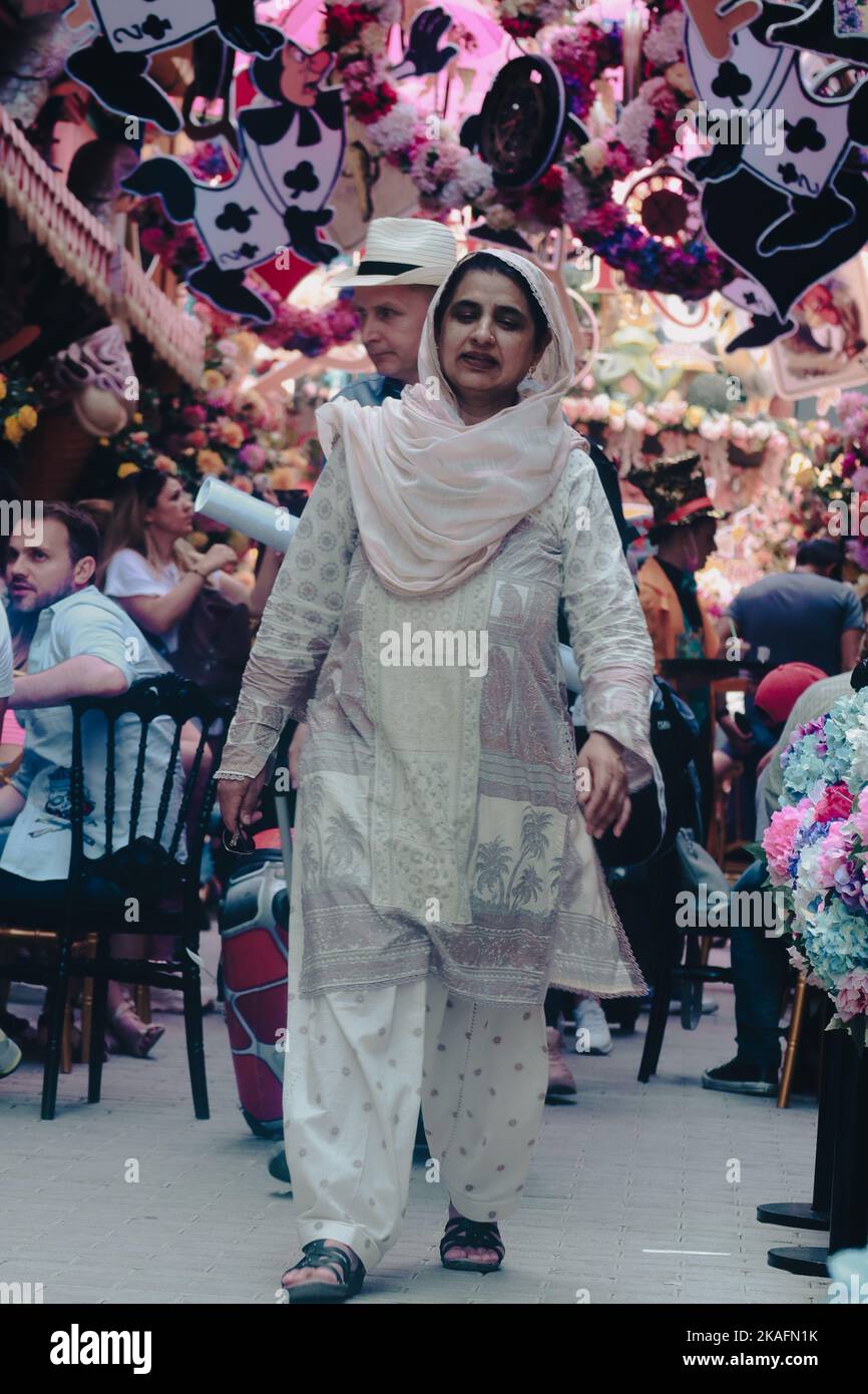 A vertical shot of an Indian woman walking down the street. Athens ...