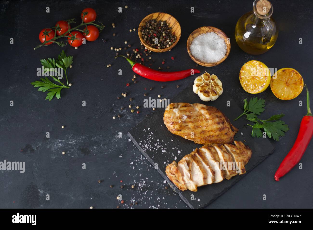 A flat ray of cooked chicken fillet with colorful vegetables and ...