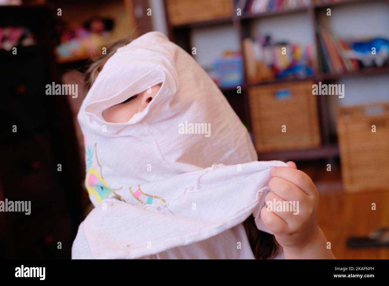 funny young girl fooling around with her tshirt while dressing Stock ...