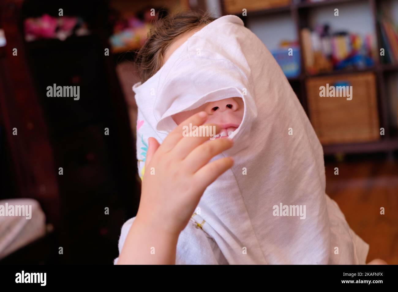 funny young girl fooling around with her tshirt while dressing Stock ...