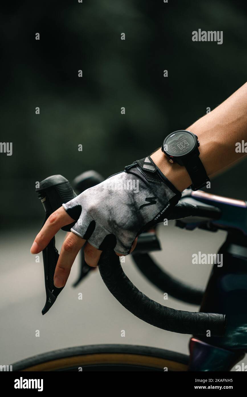 A vertical shot of a man cycling with his bike in Singapore Stock Photo - Alamy