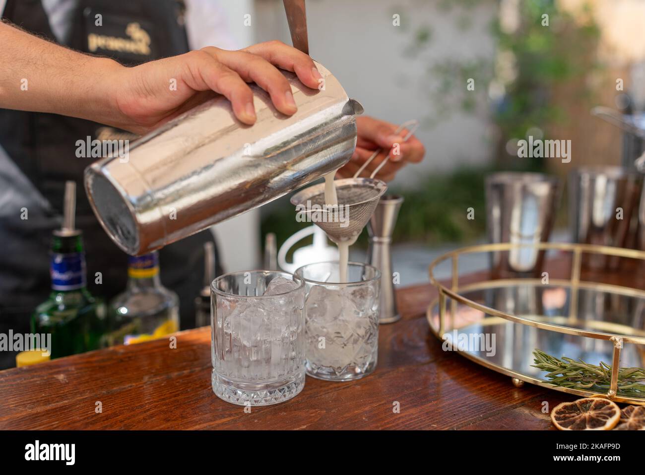 The bartender pouring a cocktail in a cup Stock Photo - Alamy