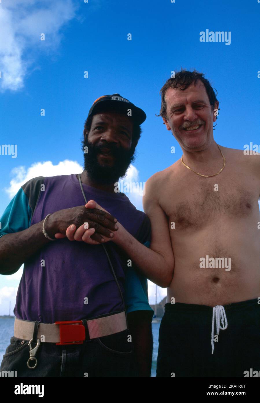 British Tourist and Local Shaking Hands on Reduit Beach Rodney Bay St ...