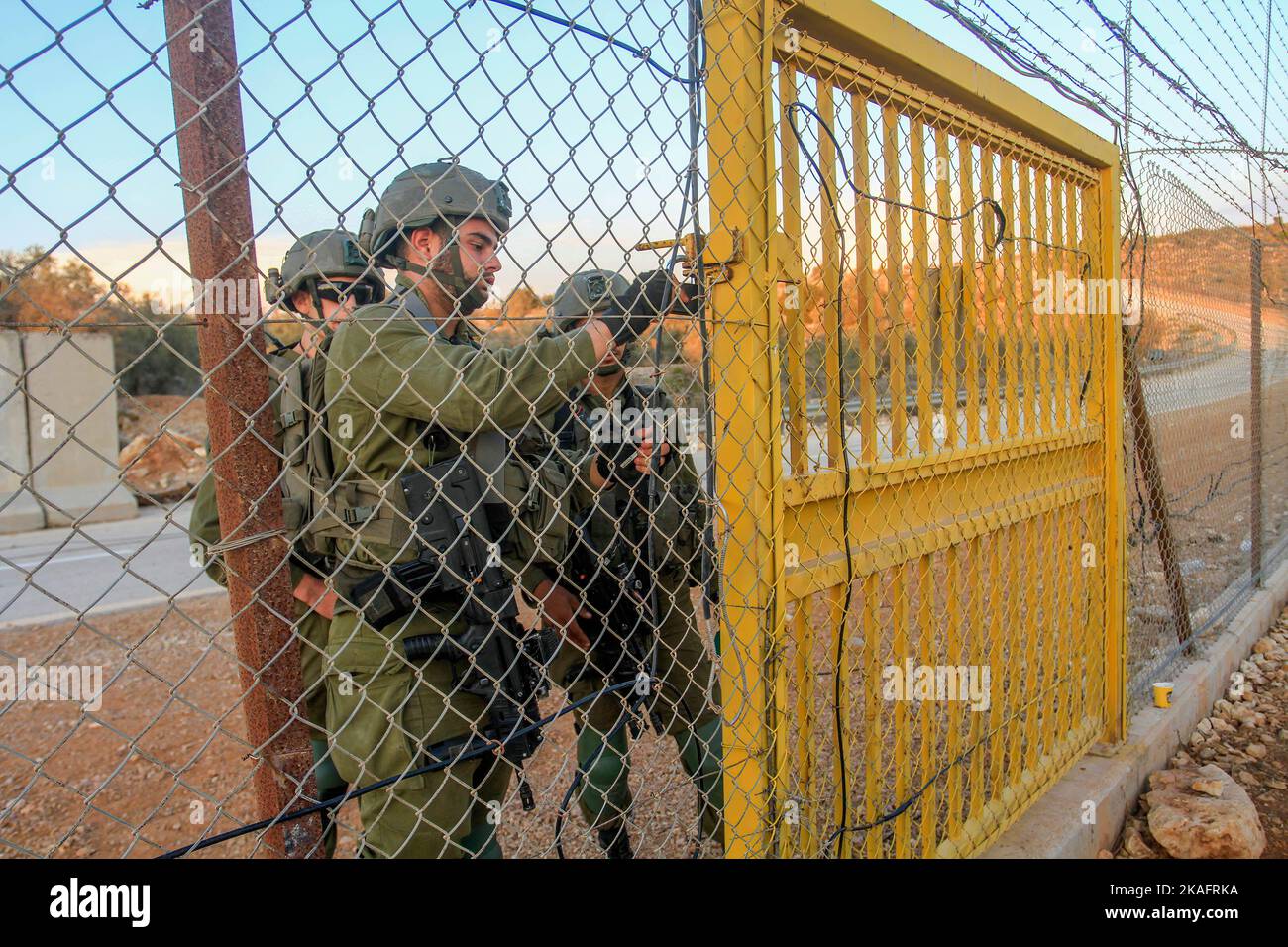 Israeli soldiers open the gate of the separation barrier in the ...