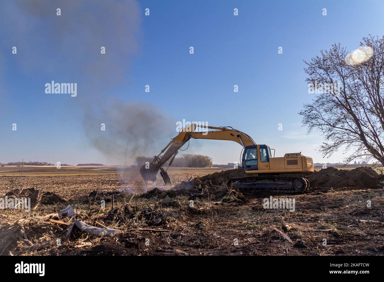 Close up view of a heavy equipment excavator moving trees and wooden ...