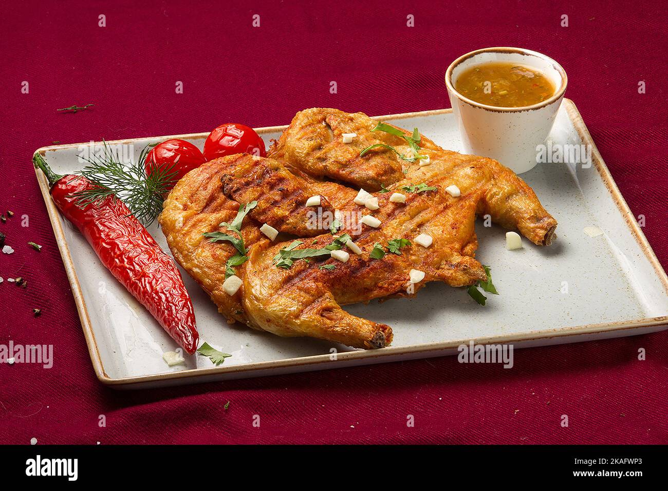 Chicken Tapaka - Georgian dish in georgian cuisine on a red background ...