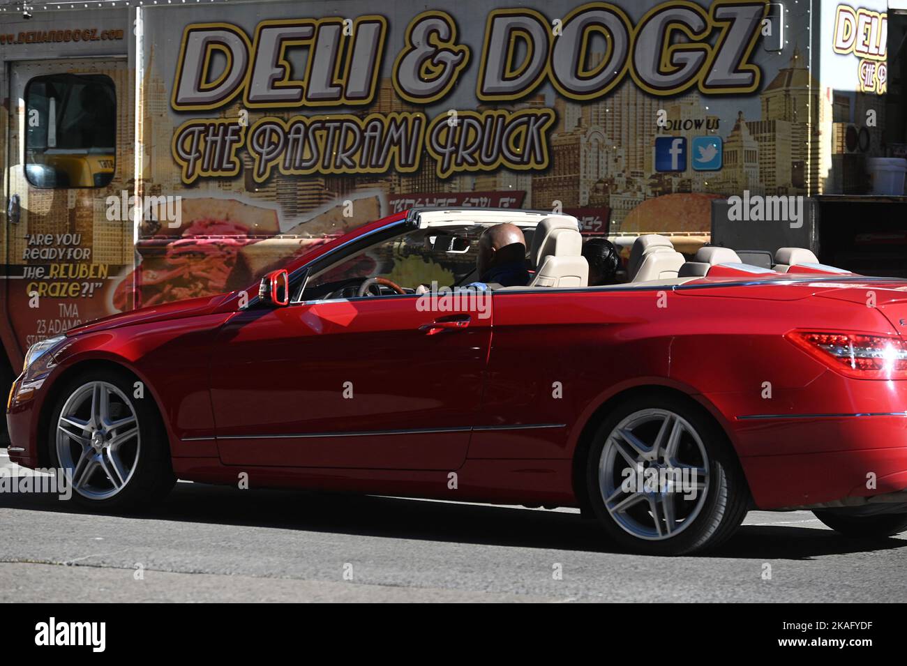 A man drives a car with the convertible top down as temperatures ...