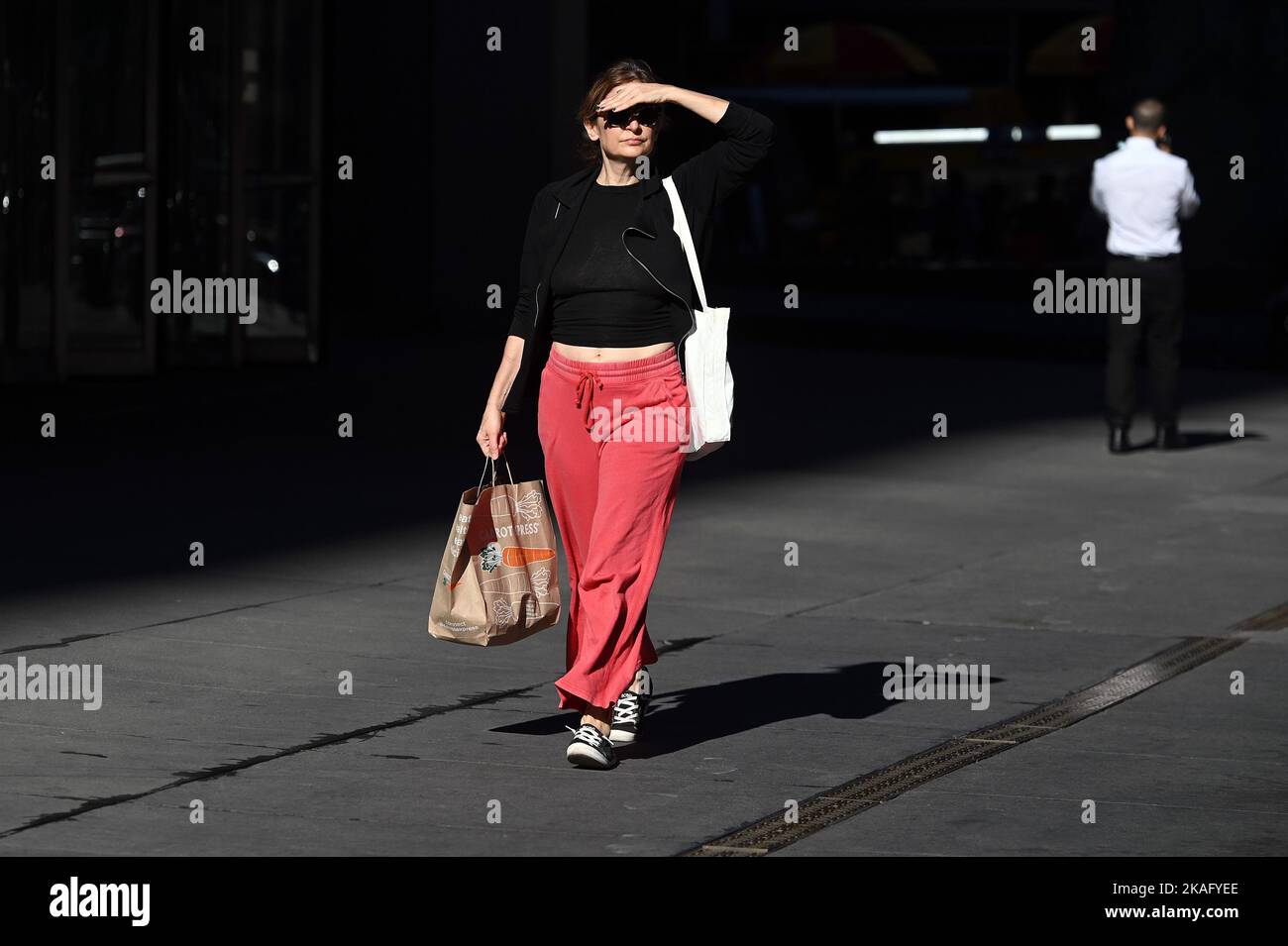People walking along 6th Avenue wearing fewer layers of clothes for ...