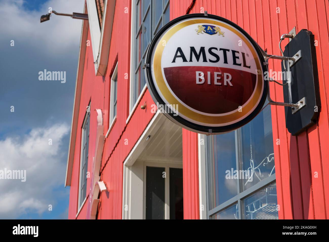 Amstel sign on a red facade in summer during daytime. Amstel is a beer ...