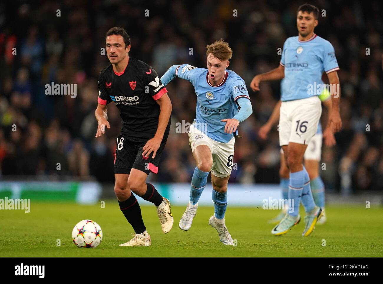 Sevilla's Thomas Delaney (left) and Manchester City's Cole Palmer ...