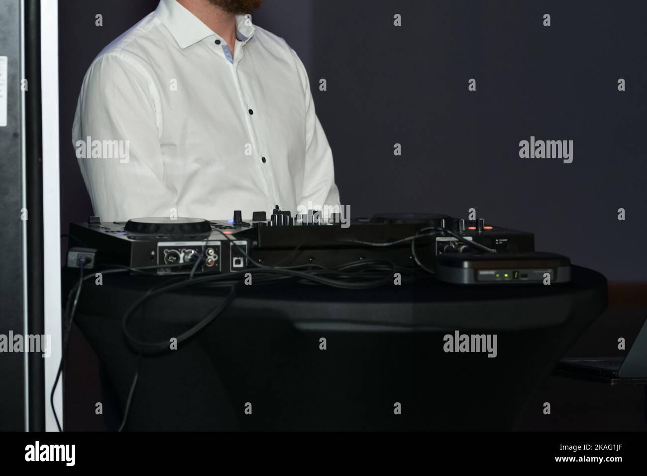 DJ in a white shirt and his equipment at a wedding Stock Photo - Alamy