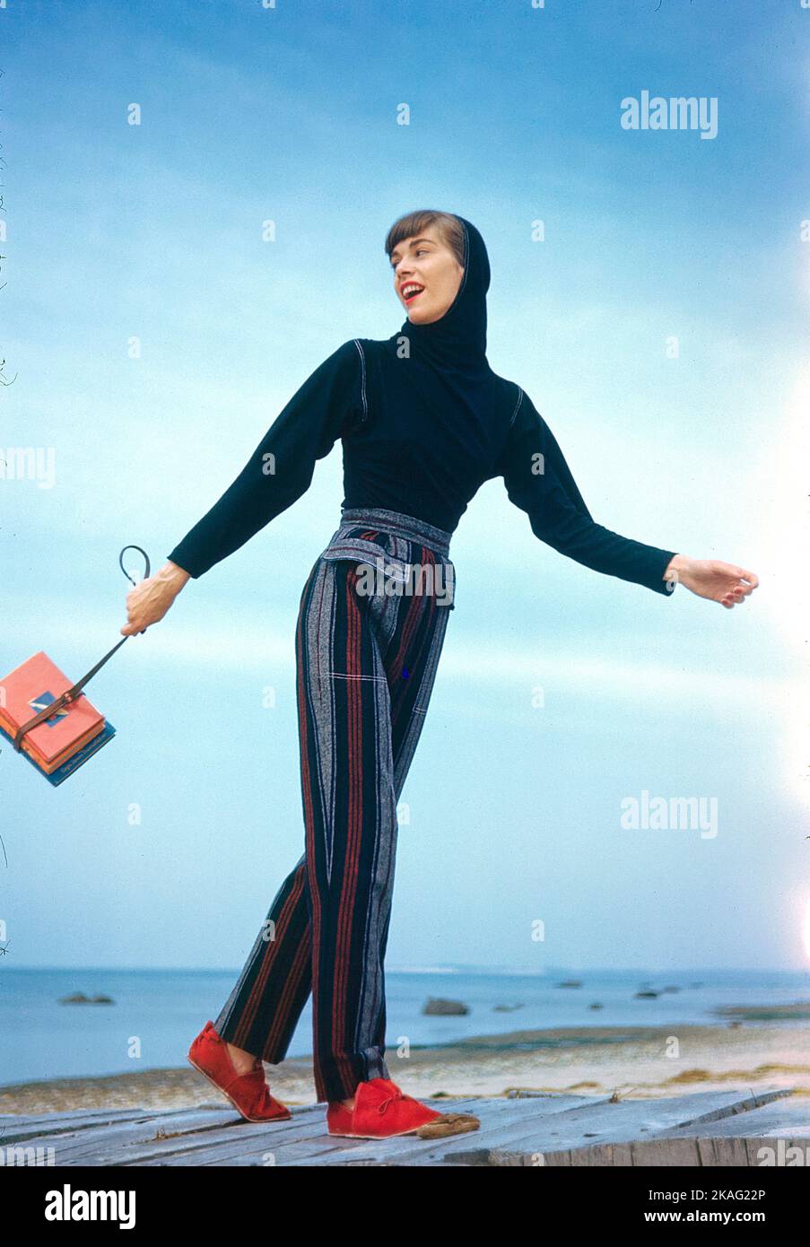 Fashionable Young Adult Woman in Striped Slacks and Hooded Top, Toni ...