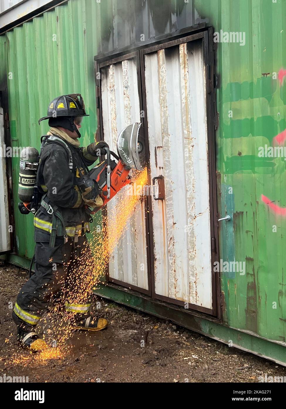 A newly hired fire fighter conducts forcible entry procedures during a ...
