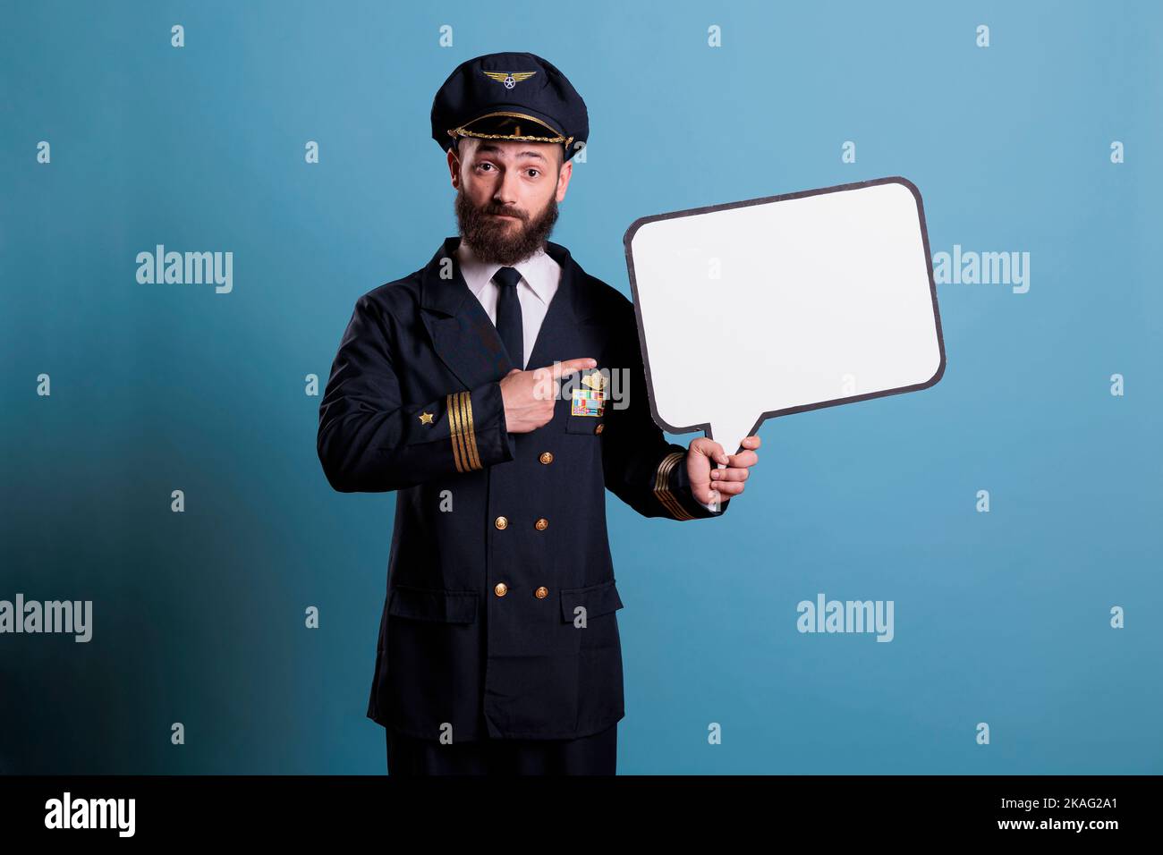 Airplane capitan pointing with finger at white blank speech bubble ...