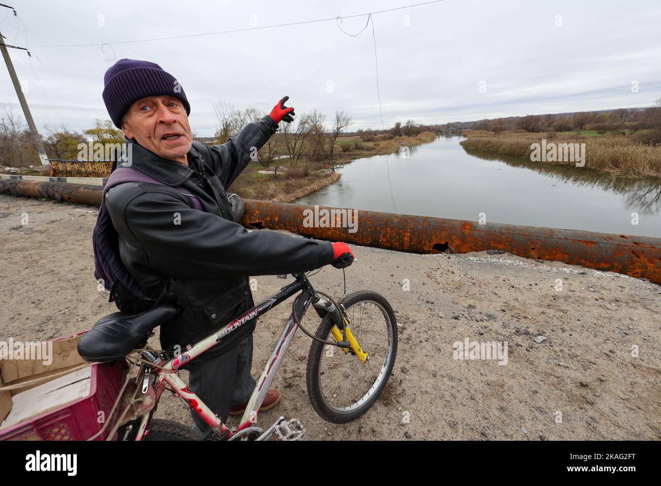 KHARKIV REGION, UKRAINE - NOVEMBER 2, 2022 - An old man with a bicycle ...