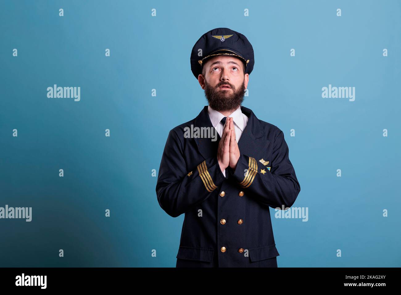 Prayer capitan in uniform praying to gods, looking upwards, standing ...