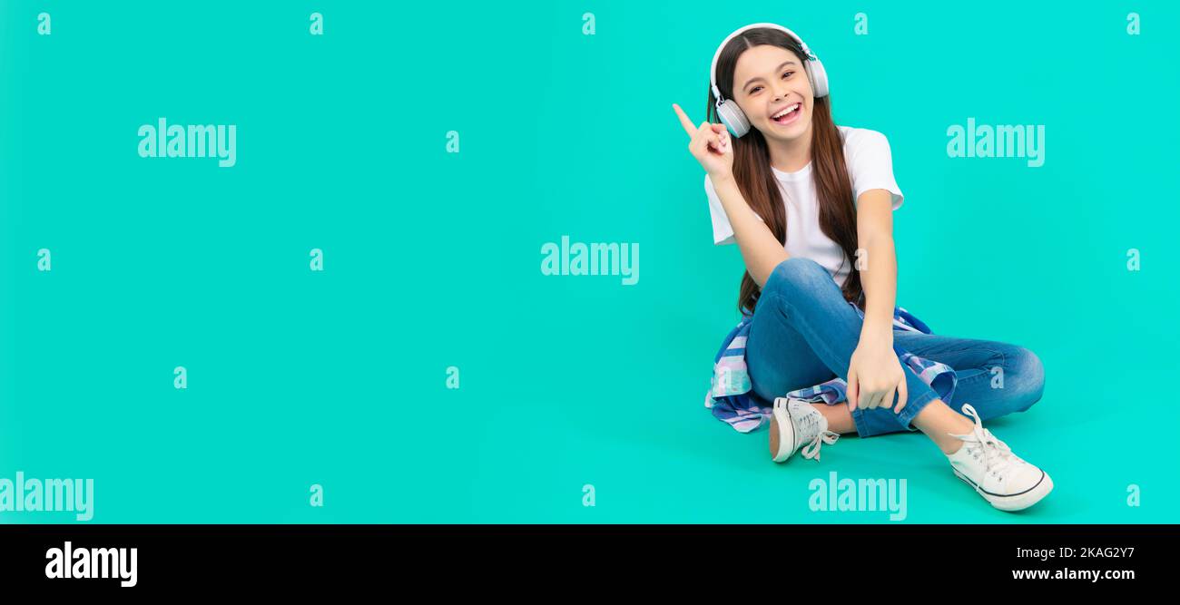 happy teen girl listen to music in wireless headphones. Child portrait ...