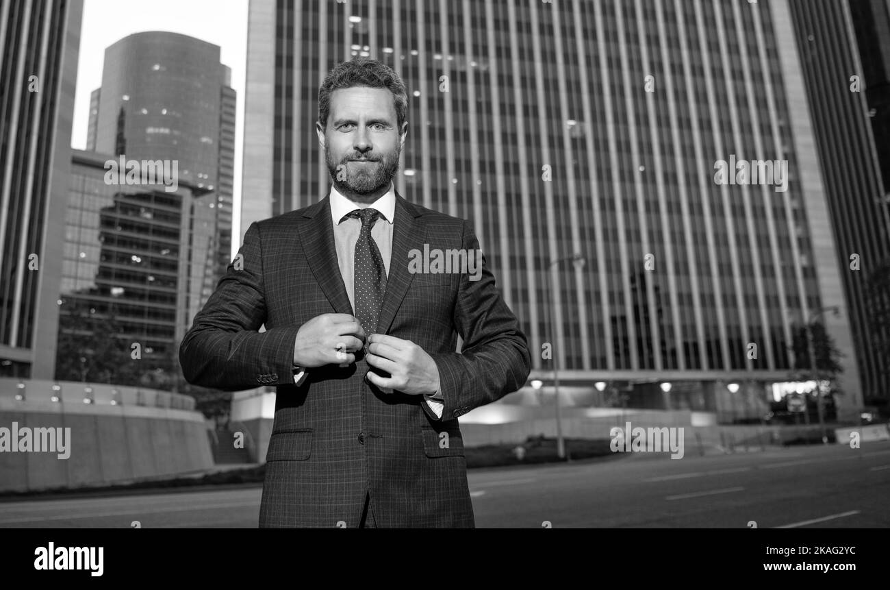 smiling entrepreneur in suit outside the office, copy space, business ...