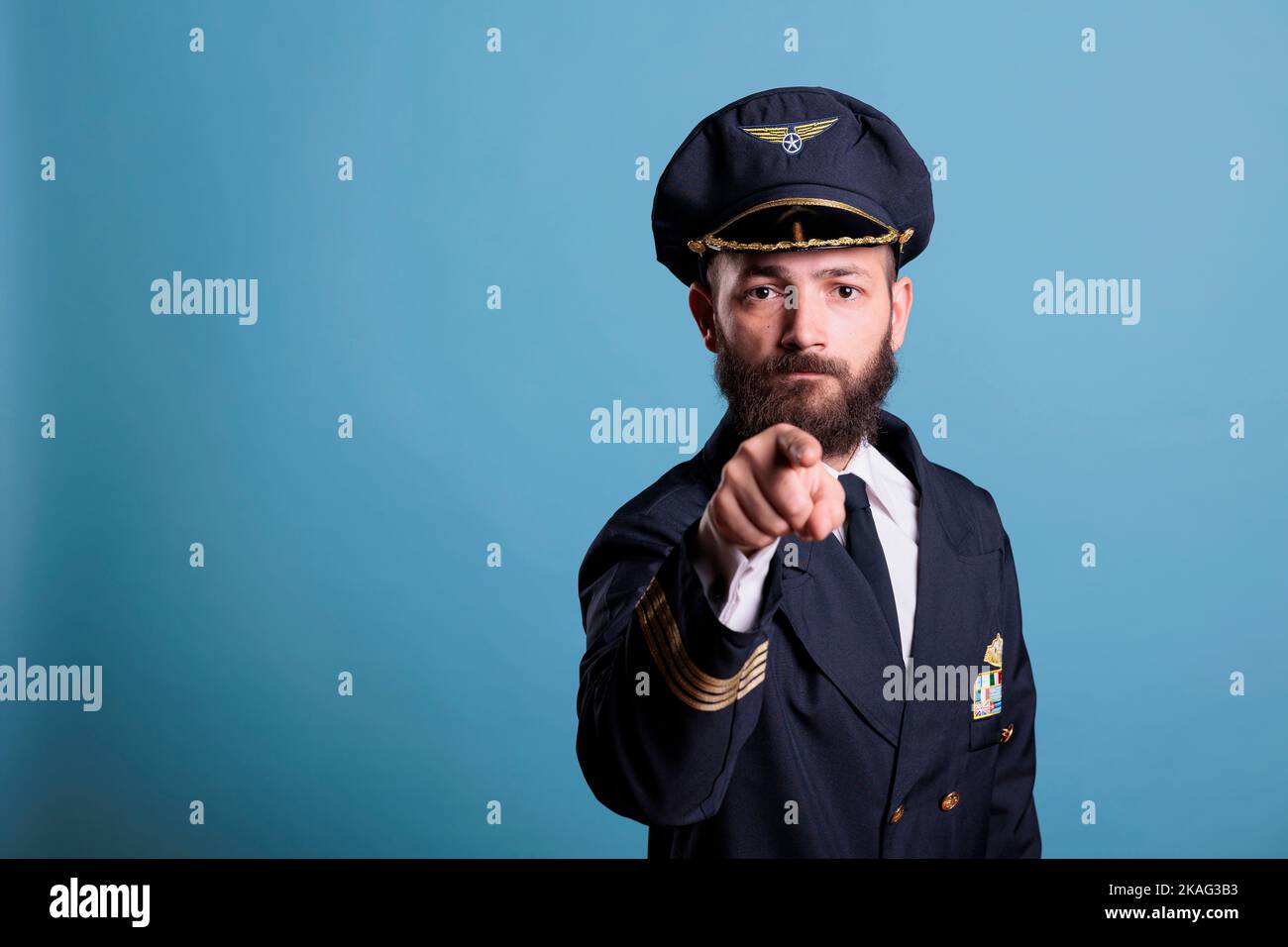 Serious airplane aviator pointing at camera with finger, aviation ...