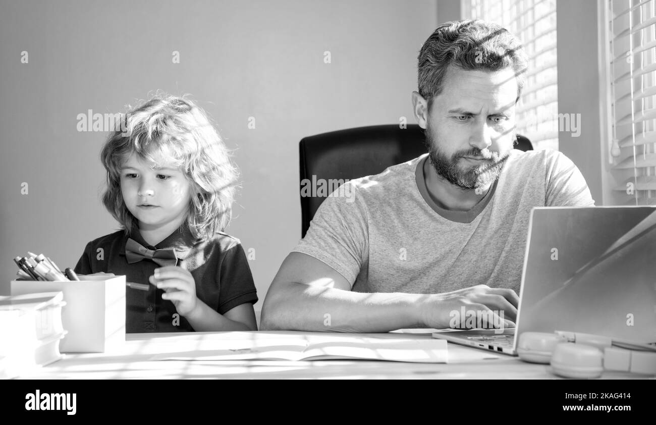 homeschooling and elearning. back to school. serious father and son use ...