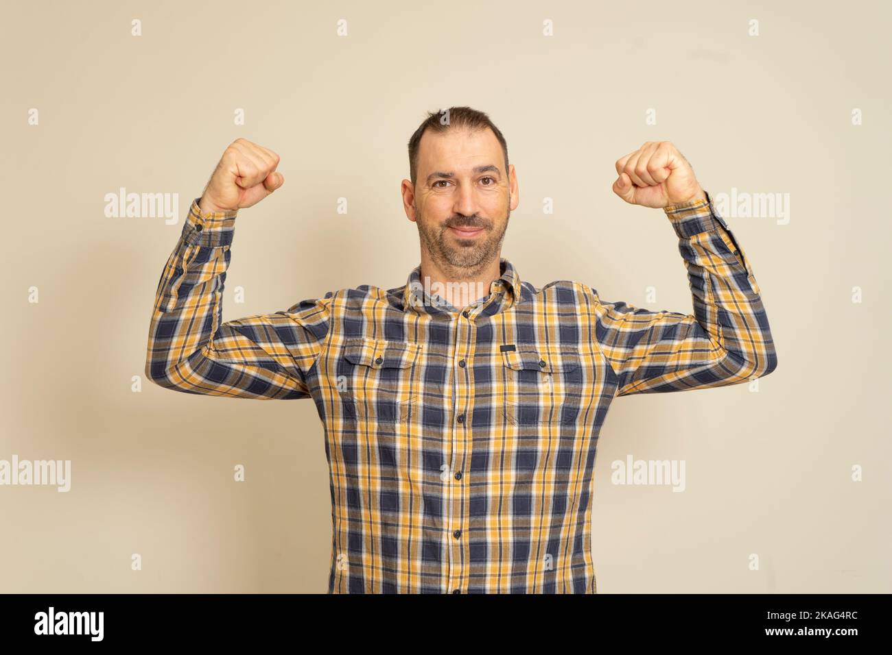 Caucasian happy unshaven strong 40 year old man in plaid shirt showing ...