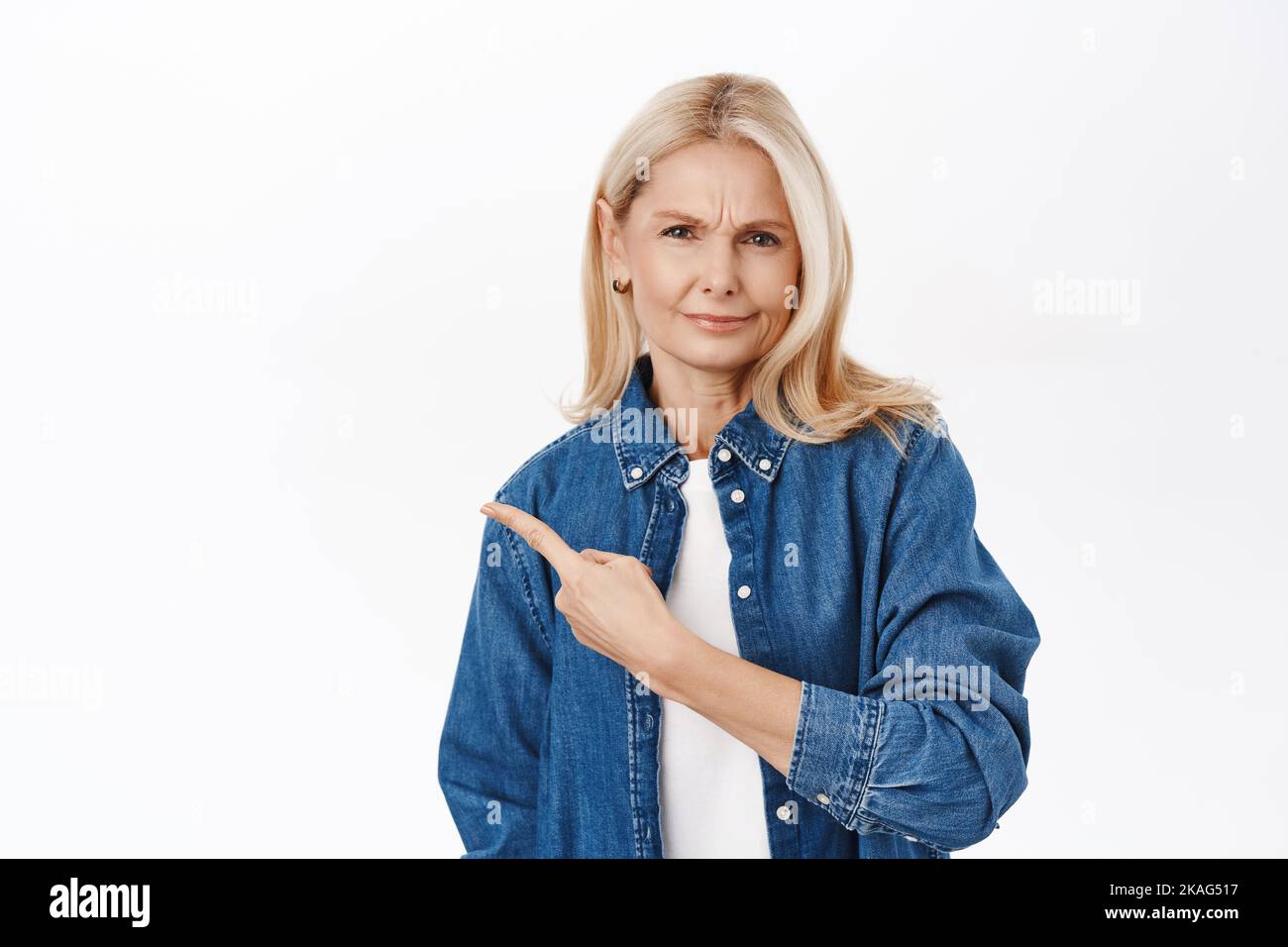 Portrait of skeptical, disappointed grandmother, senior woman pointing ...