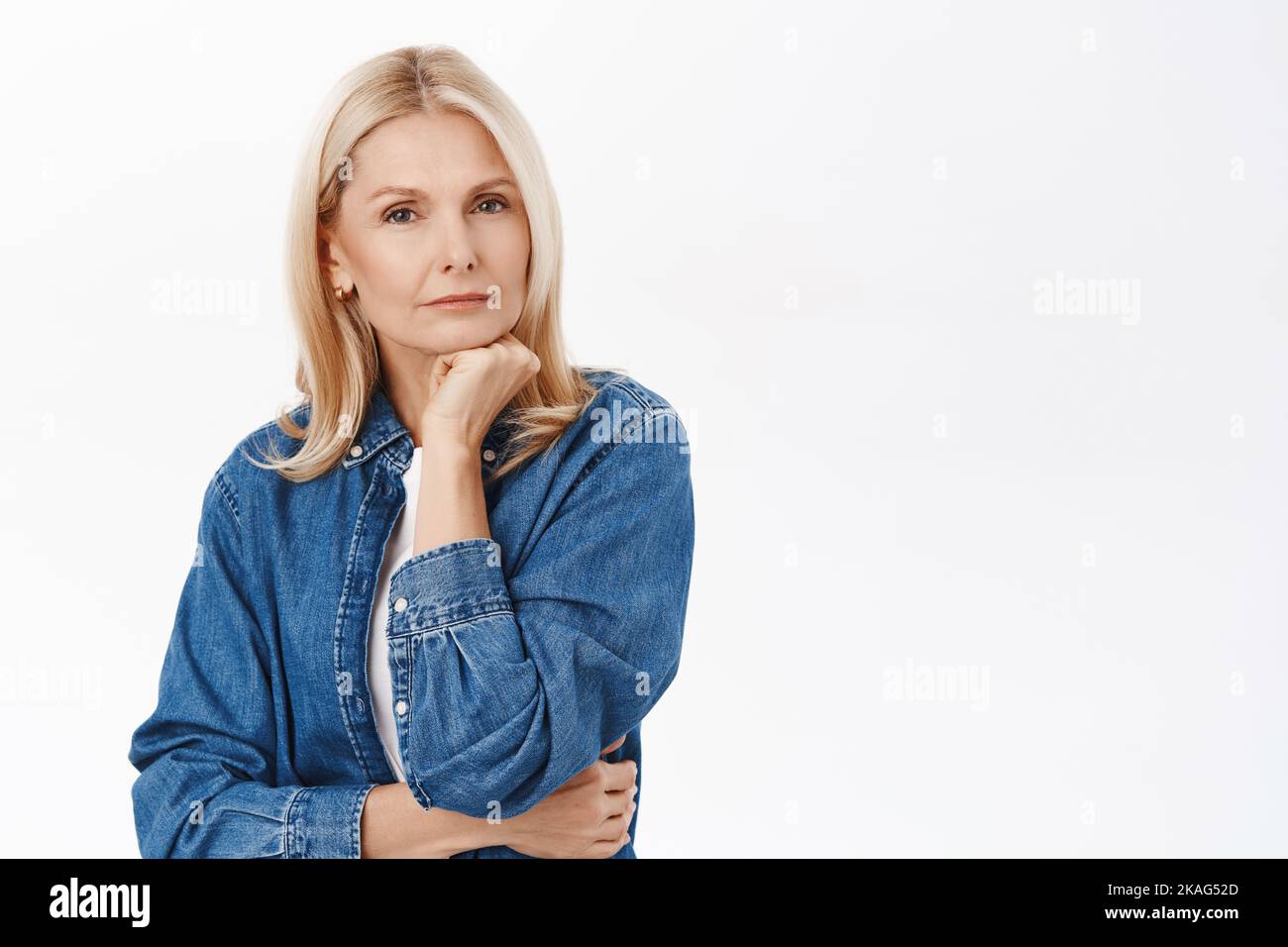 Blond senior woman, elegant grandmother, looking serious and concerned ...