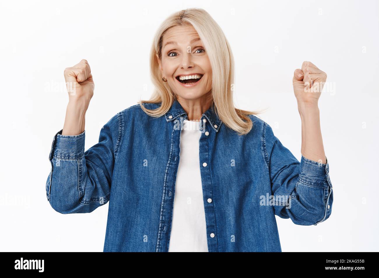 Enthusiastic middle aged woman, senior lady celebrating, triumphing and ...