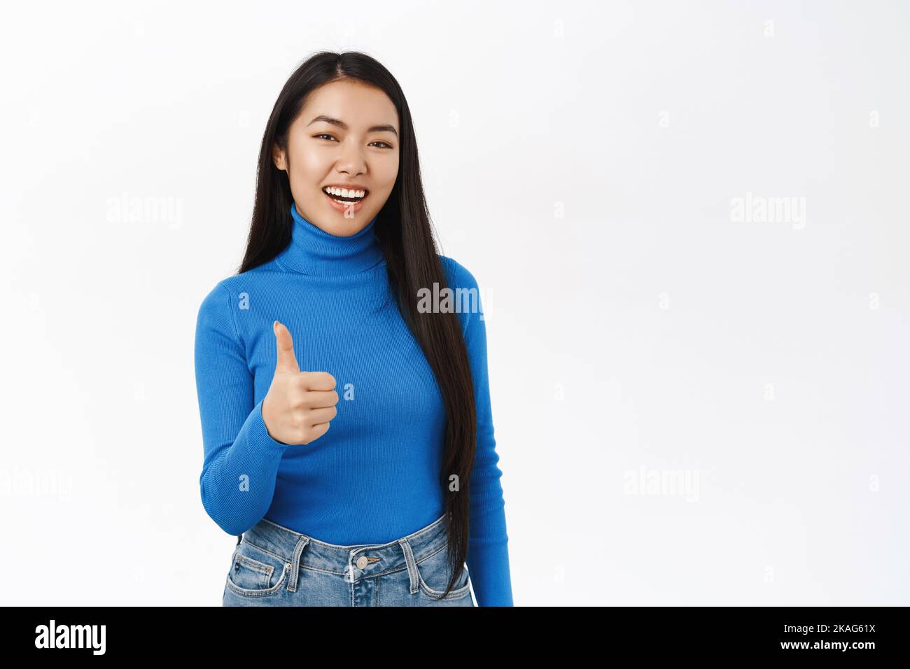 Good job. Smiling beautiful asian woman shows thumbs up, like approval ...