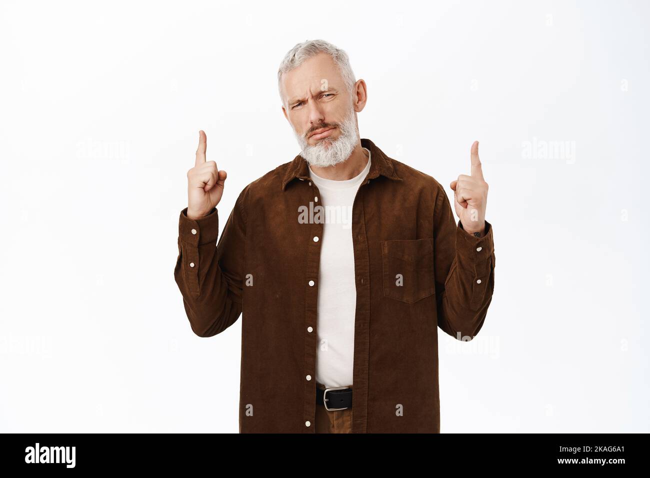 Sad, reluctant old man, senior guy pointing fingers up and looking ...