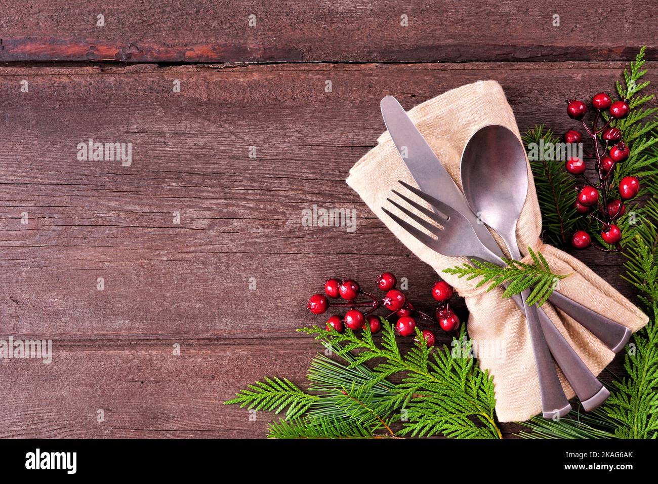 Christmas or winter table setting corner border. Cutlery and napkin ...
