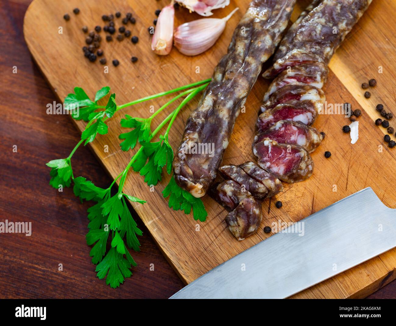 Dry pork sausage with condiments on table Stock Photo - Alamy