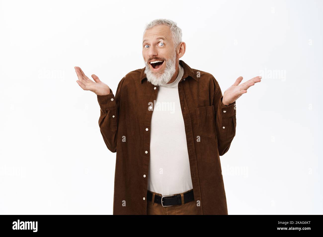 Surprised old man, senior caucasian guy shrugging shoulders and looking ...