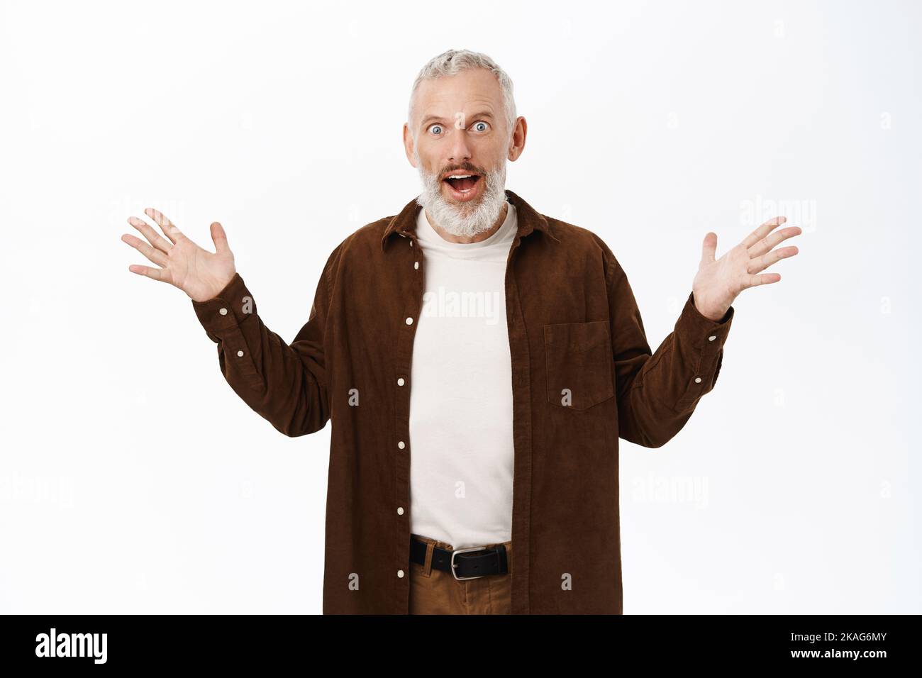 Amazed old man, showing smth big, spread hands sideways and staring ...