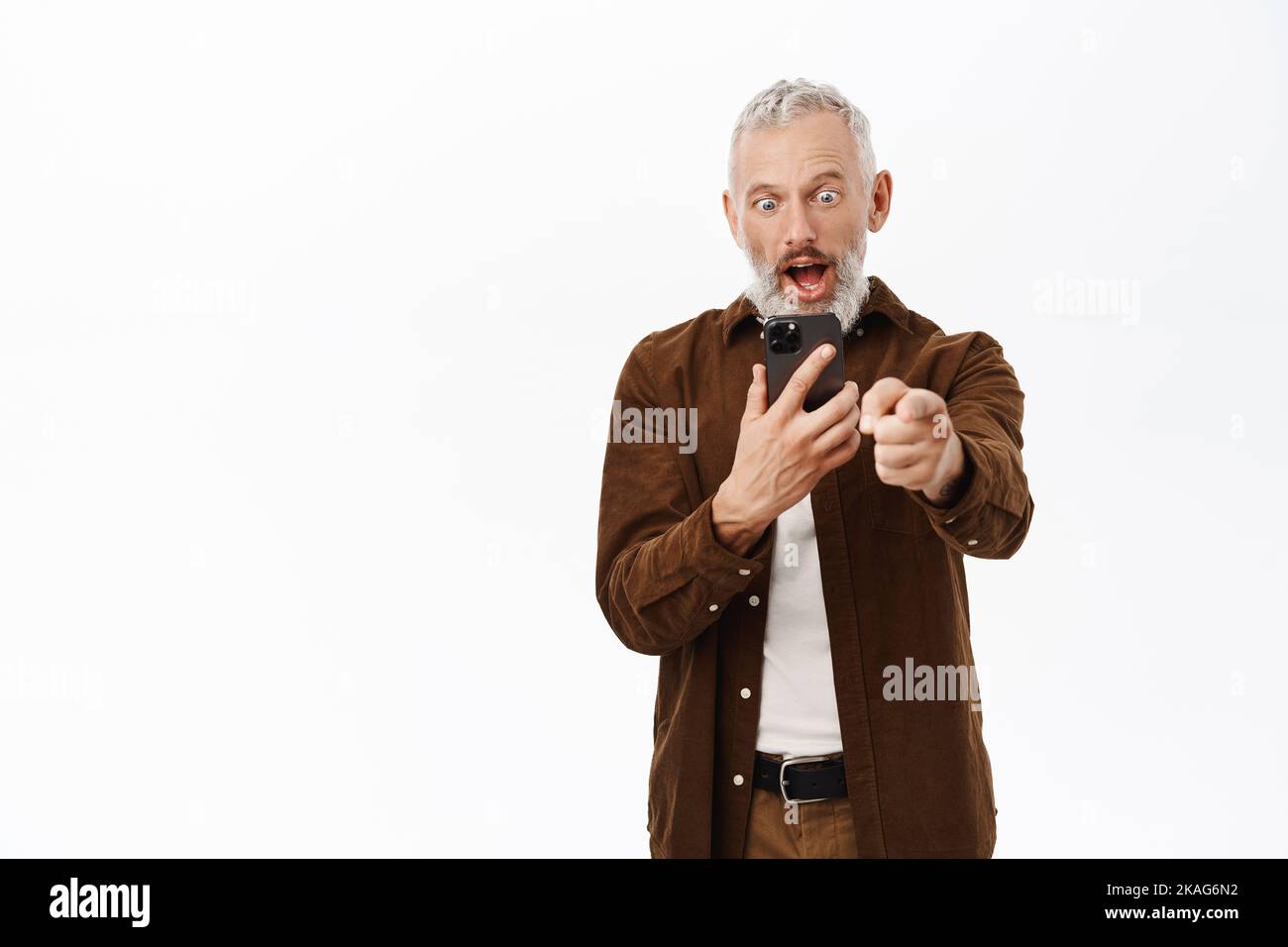 Senior man, mature guy pointing finger at camera and recording video ...