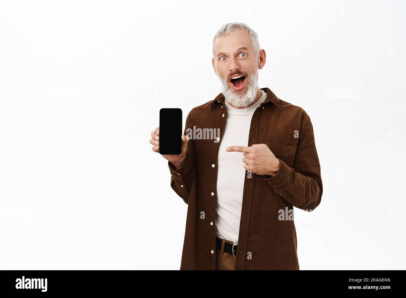 Mature man, old guy pointing finger at mobile phone screen, showing ...