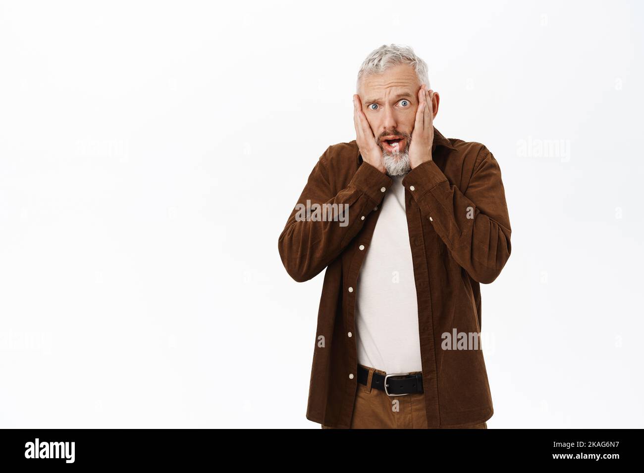 Shocked mature man, old male model looking speechless and stunned at ...