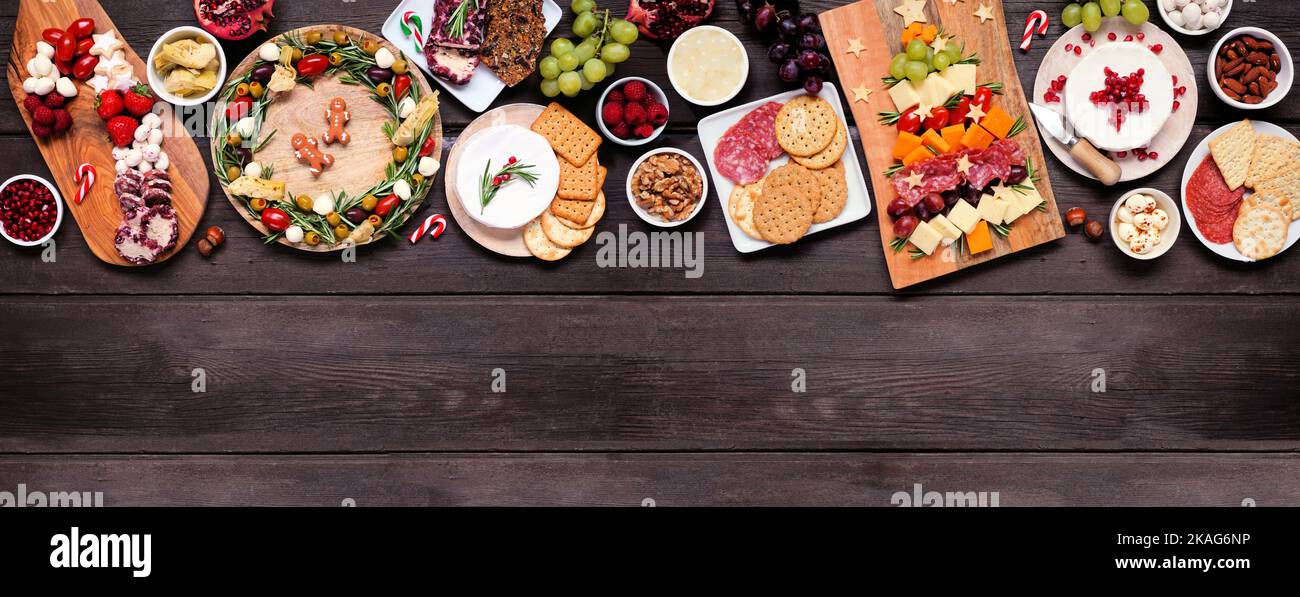 Christmas charcuterie top border against a dark wood banner background ...
