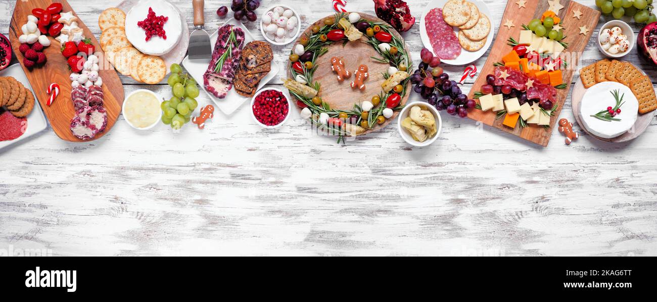 Christmas charcuterie top border against a white wood banner background ...