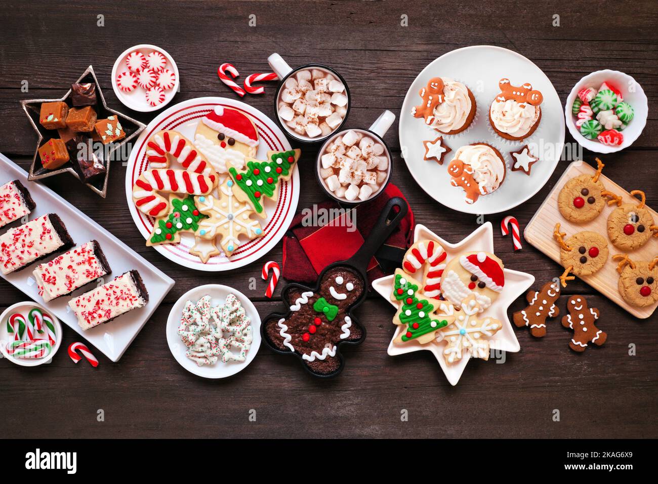 Cute Christmas sweets and cookie table scene. Top down view on a rustic ...