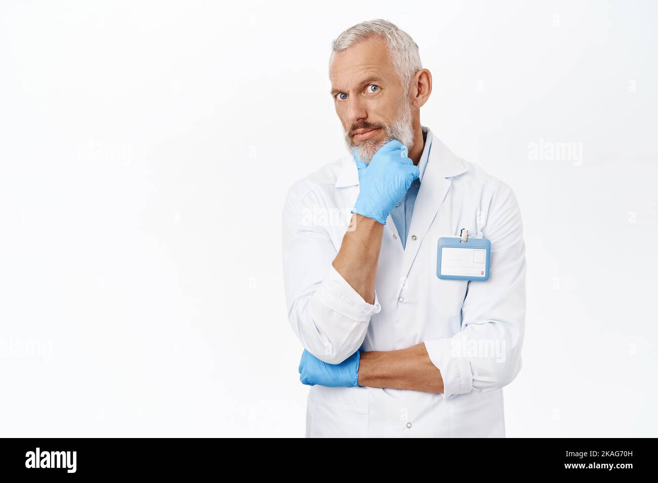 Doctor thinking, wearing uniform, looking thoughtful at camera ...