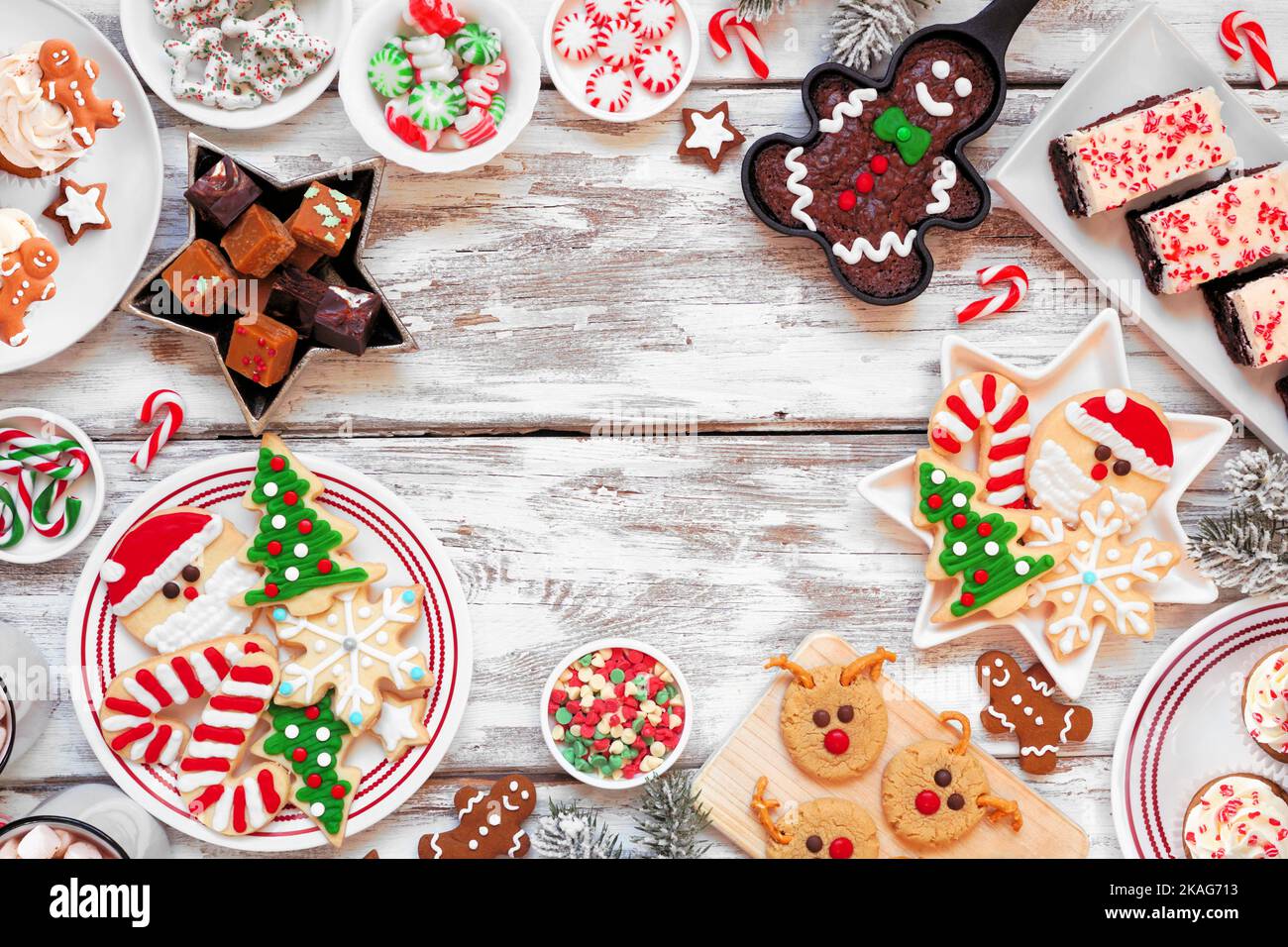 Cute Christmas sweets and cookie frame. Overhead view on a rustic white ...