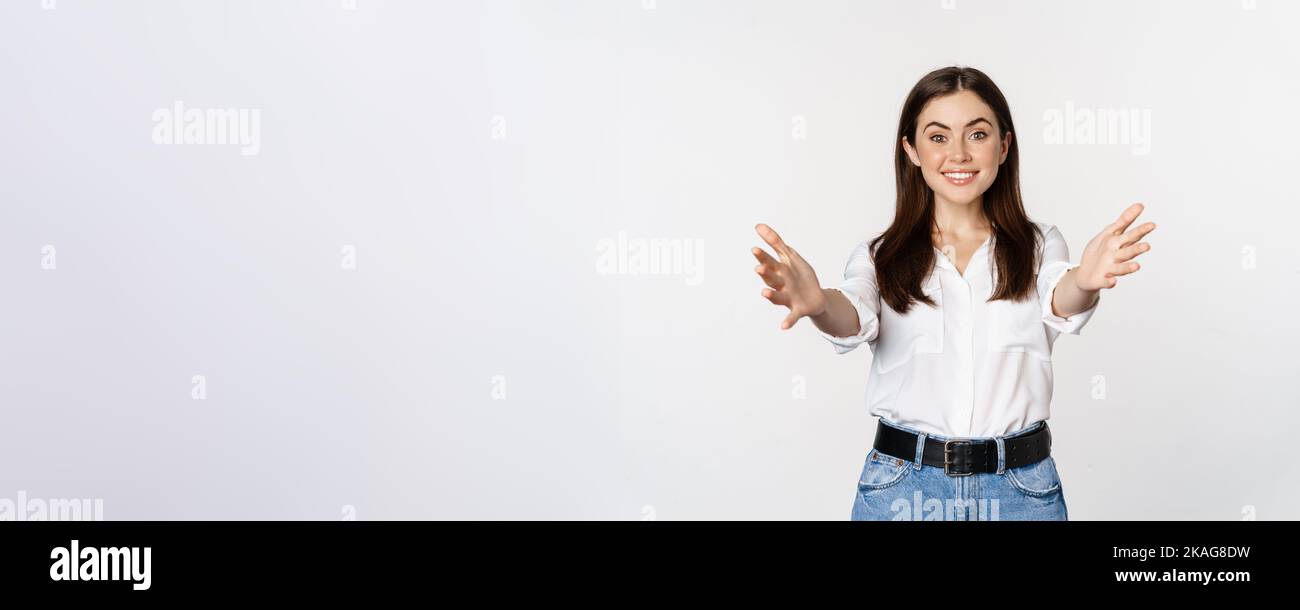 Enthusiastic laughing woman, smiling and stretching out arms forward ...